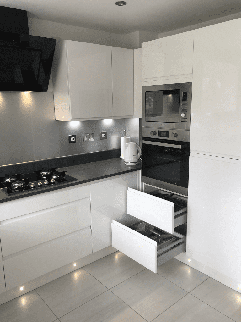 Minimalist Handle-less Kitchen Design In Gloss White Finish